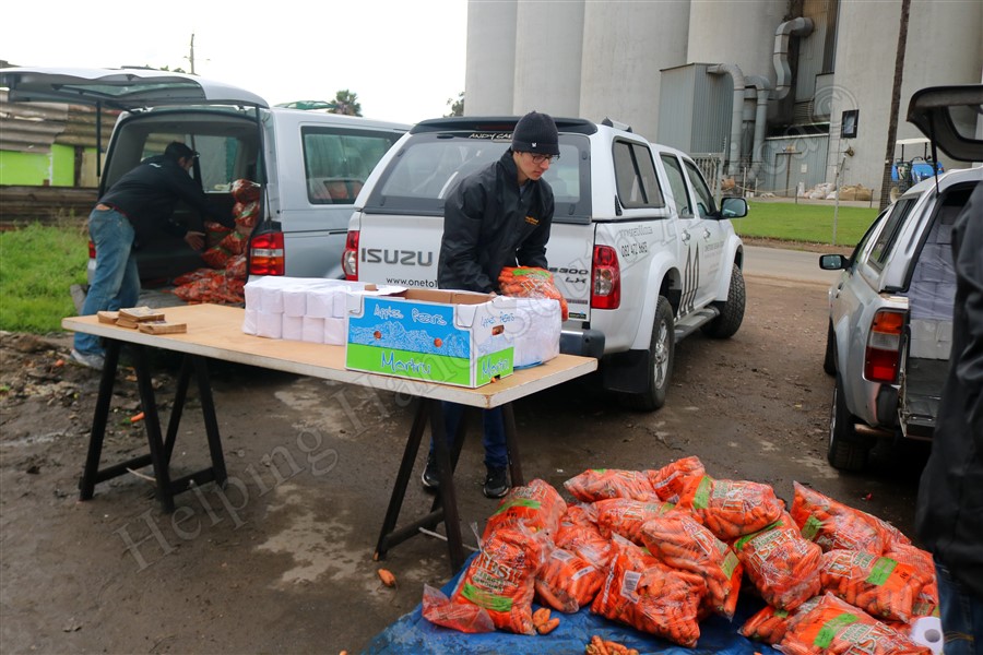 In the Rain and Cold; Food Parcels for Over 500 People – Helping Hand ...